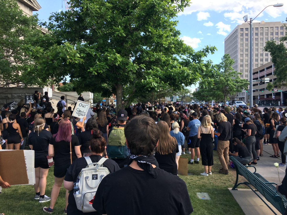 Protesters in Colorado Springs Thursday are clad in black, carrying ...
