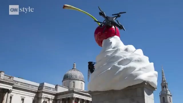 A giant swirl of whipped cream topped with a cherry, a fly and a drone ...