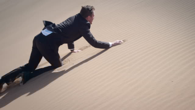 Man Crawling In Desert