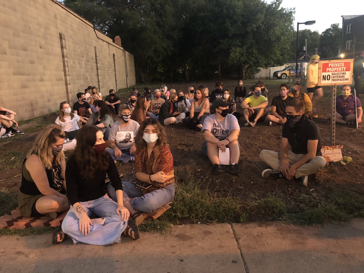 At a protest, a sit in, over a destroyed Community garden. Protestors ...