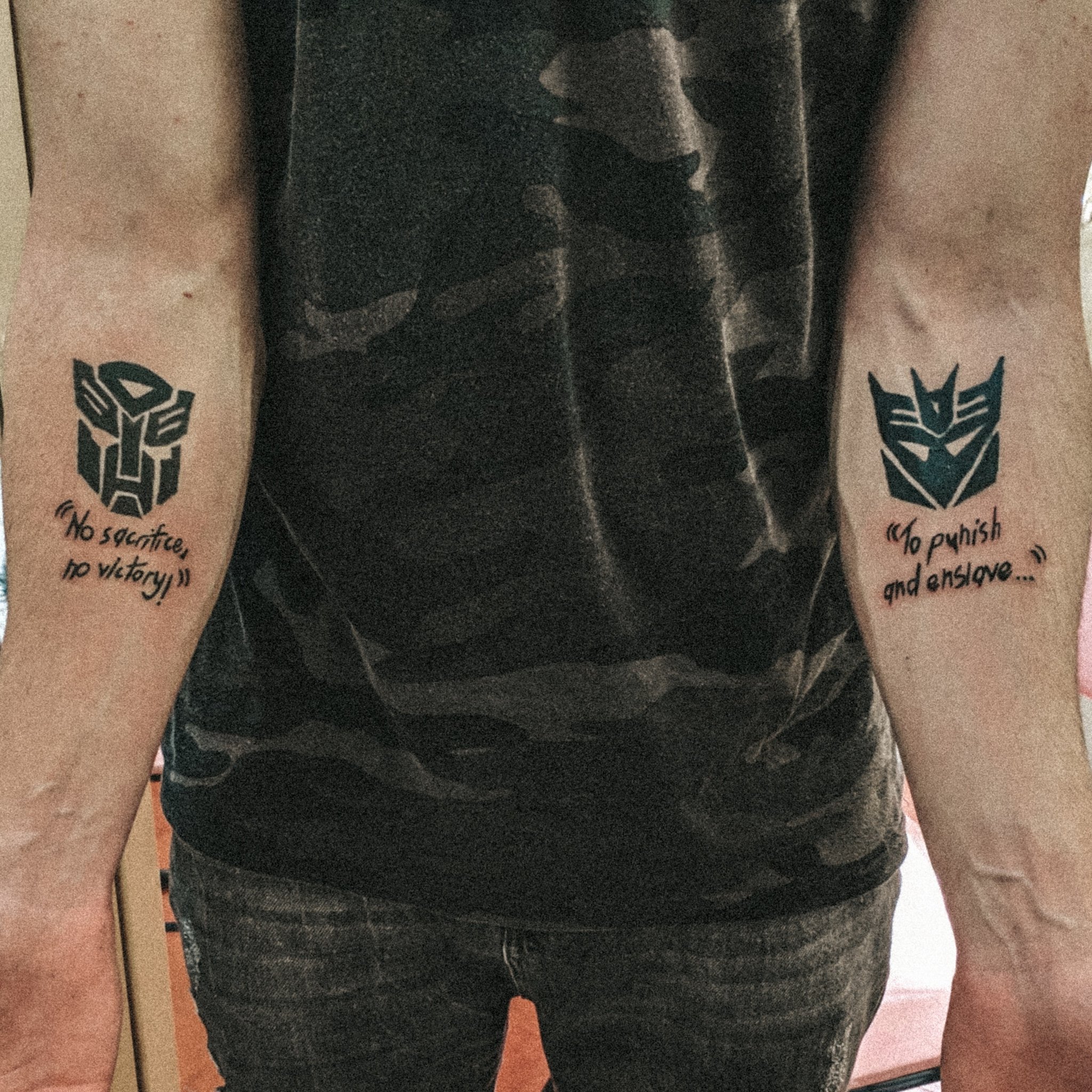 Decepticon And Autobot Logo Tattoo