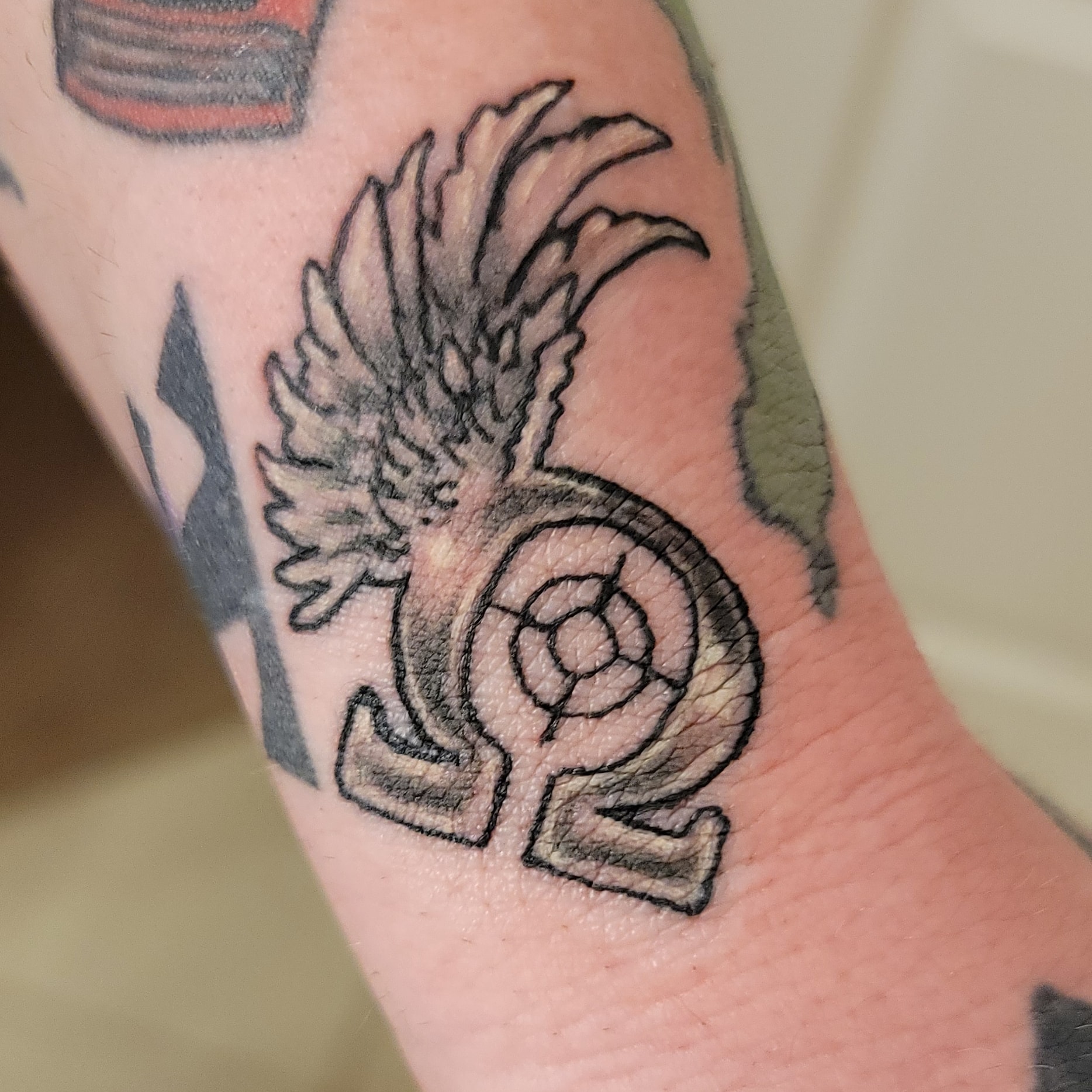 White Omega Tattoos