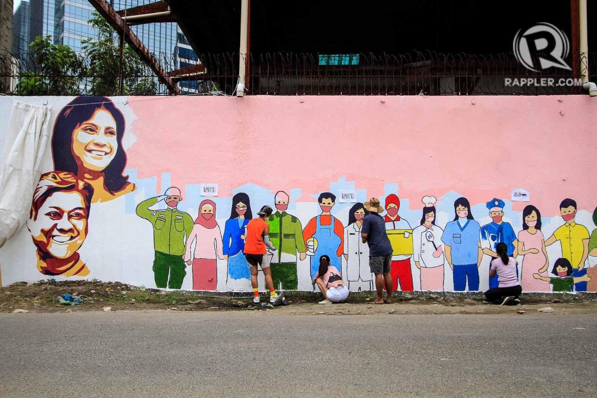 Artists paint a mural of VP Leni Robredo on a wall of the Anthill ...