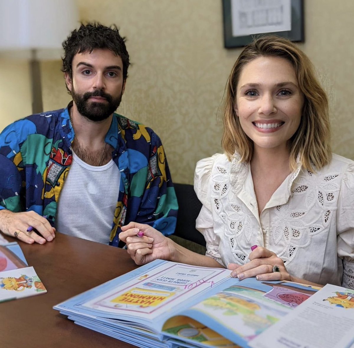 Elizabeth Olsen and husband Robbie Arnett signing copies of their book ...