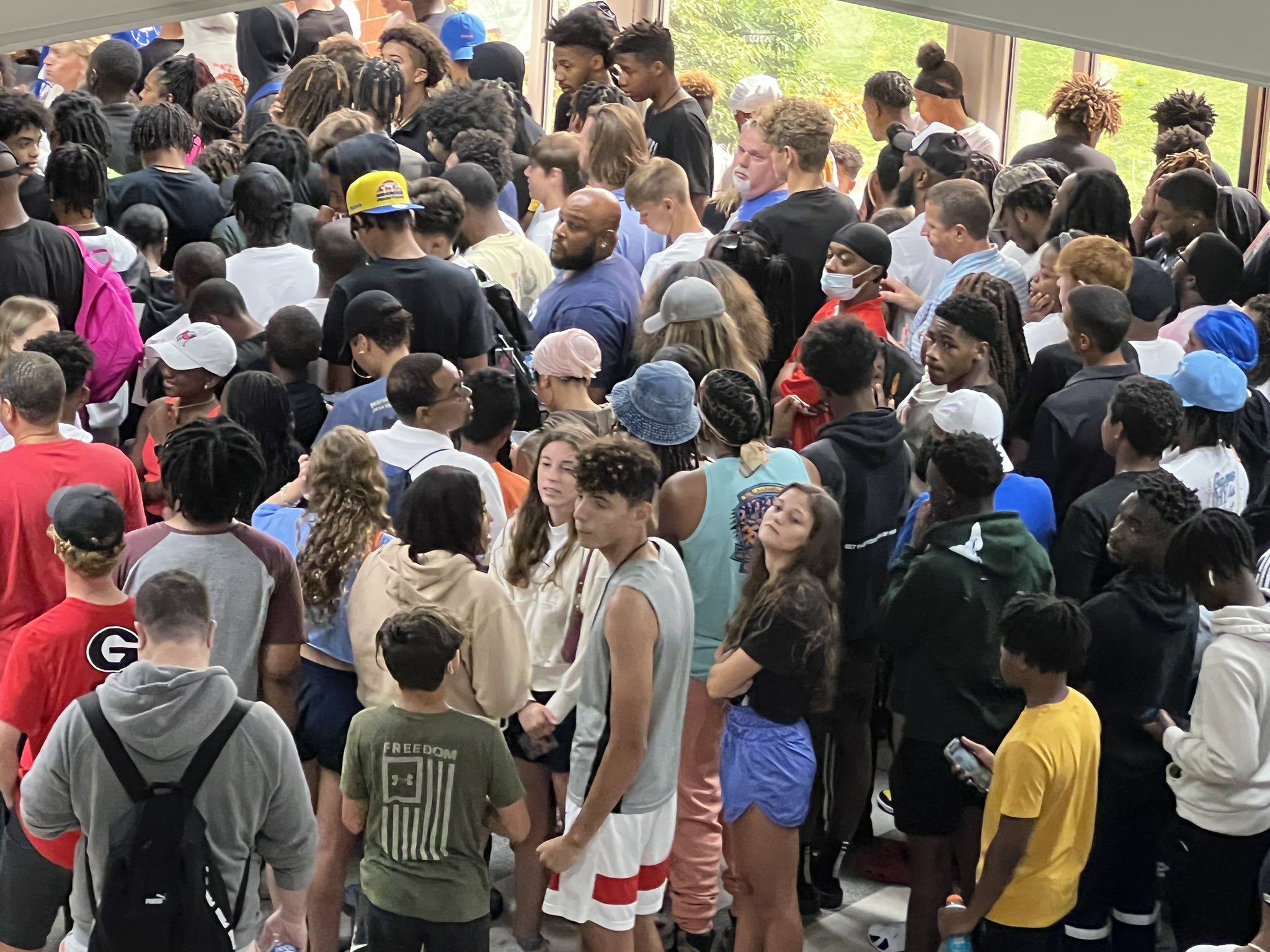 One Person Standing Up In A Crowd
