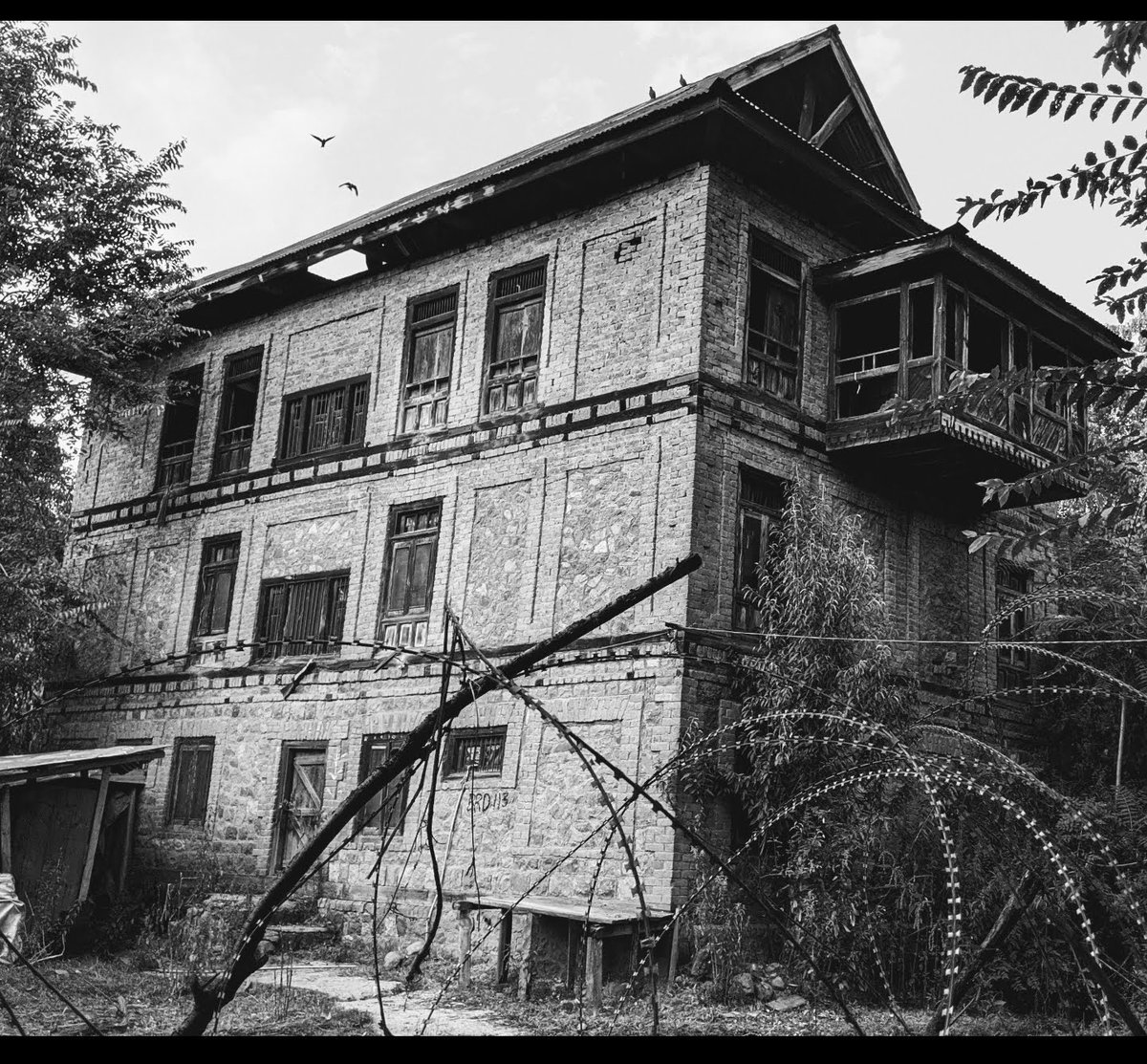 A Pandit housewife repairing the chulah (fireplace) in her kitchen ...