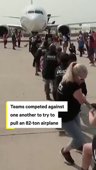 Nearly 100 teams of 25 people competed in a 'plane-pulling' competition ...