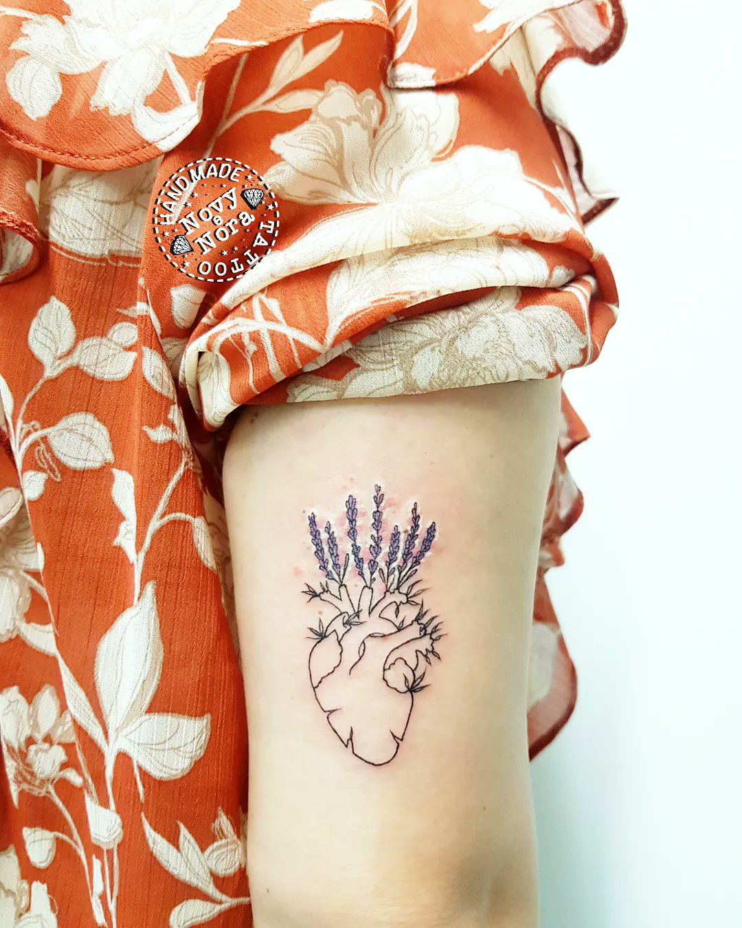 Hand Holding Heart Tattoo