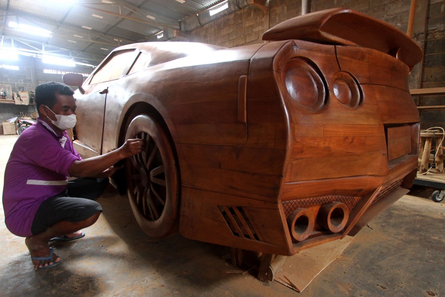 Different wooden craft vehicles, including cars and motorbikes, are ...