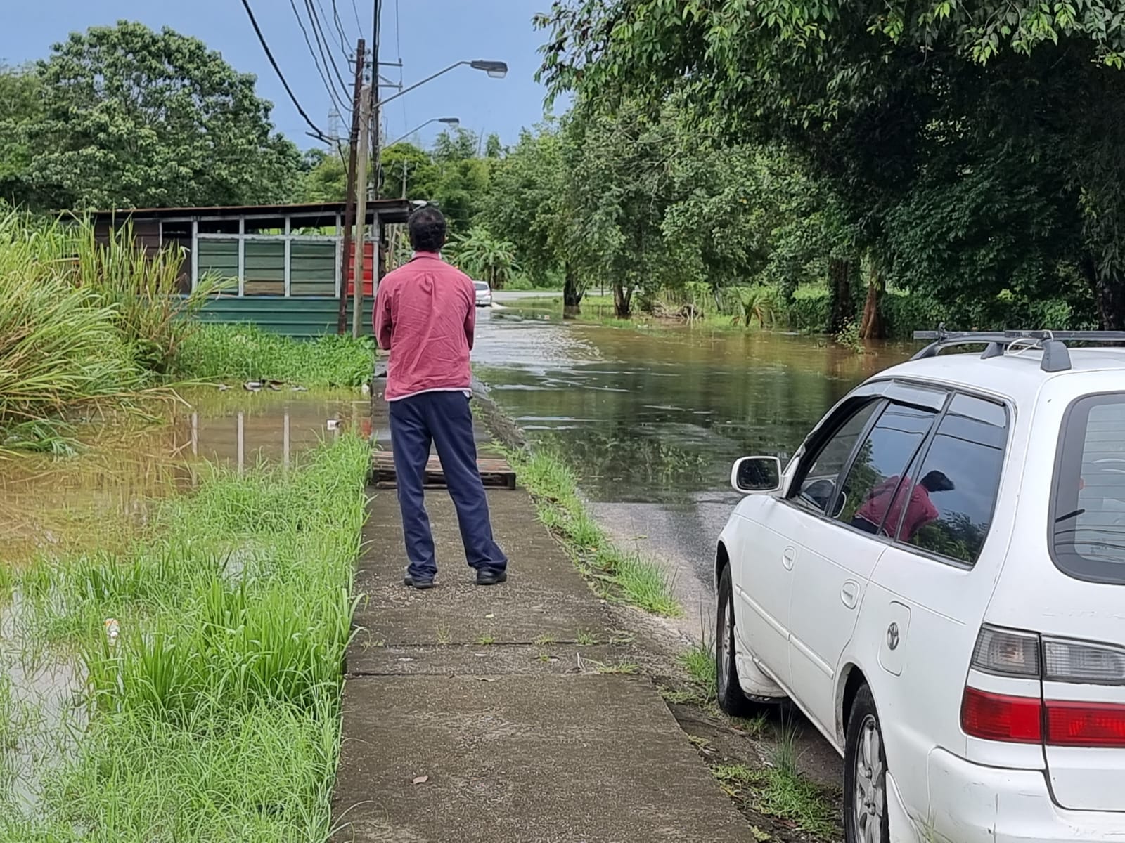 CNC3TV on Twitter: "A stranded motorist looks on as flood waters cross the Caroni South Bank ...