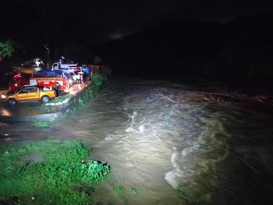 Disaster response personnel in Teresa, Rizal, monitor the Morong River ...
