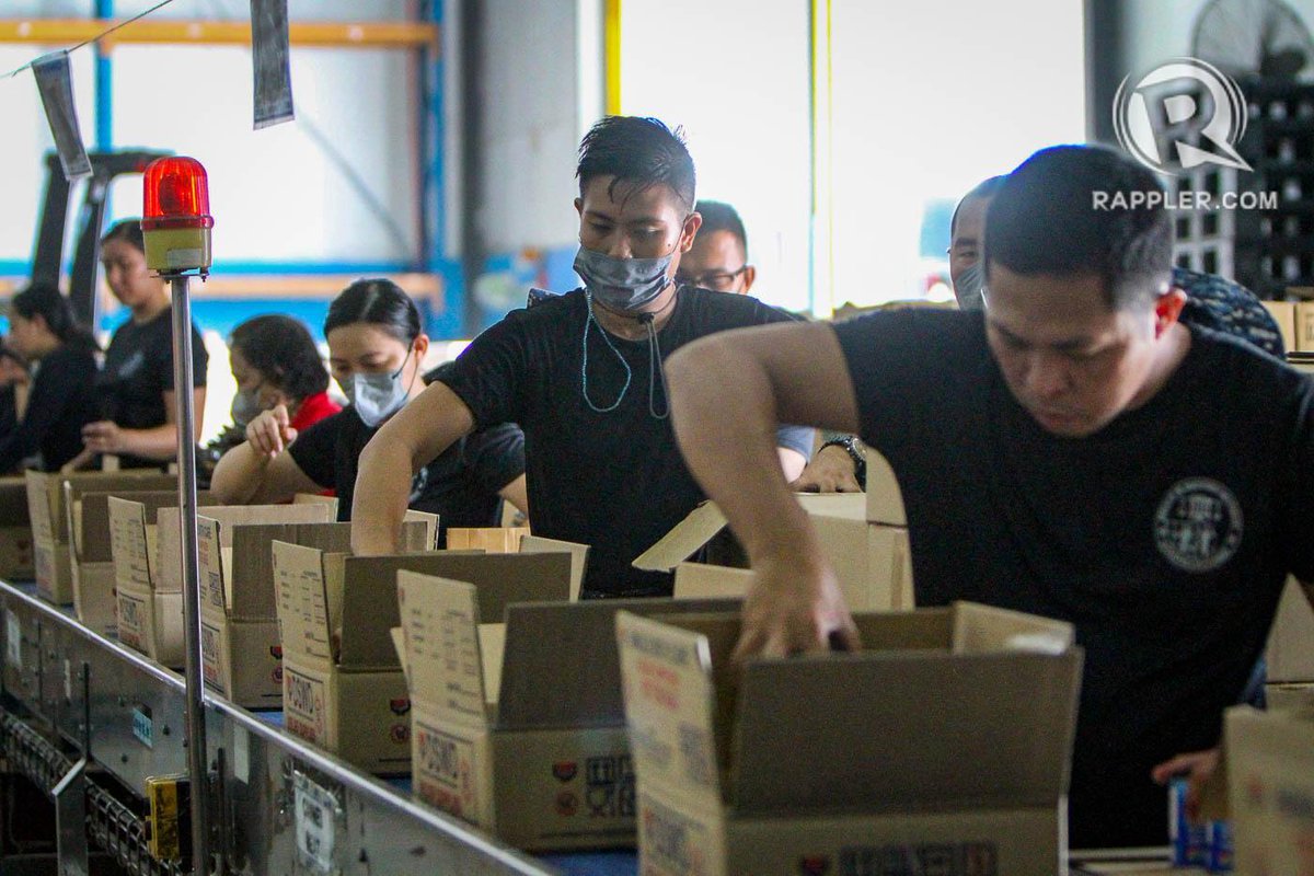 Military, police, and other volunteers repack relief goods to be ...