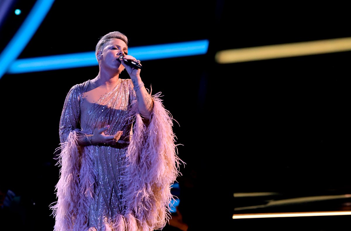 P!nk (@Pink) has taken to the #AMAs stage to pay tribute to Olivia ...