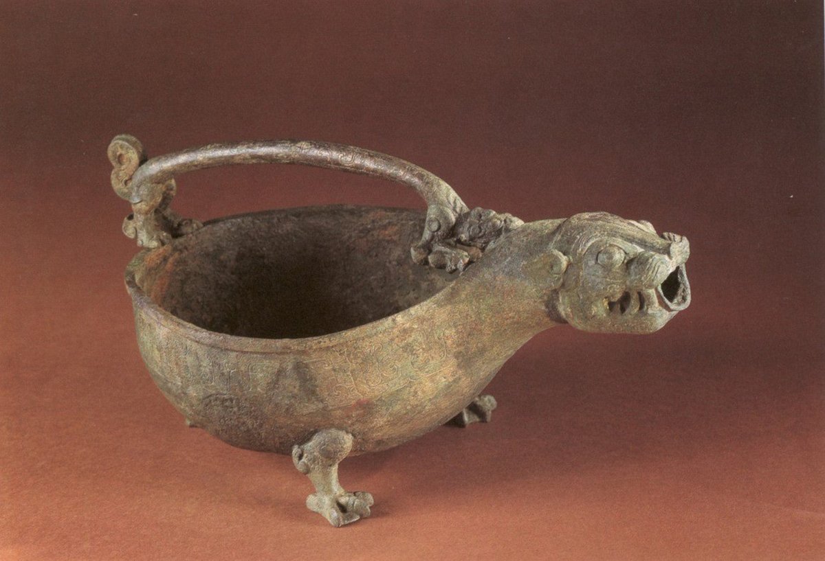 A ritual hand-washing bowl made of bronze in the shape of a tiger ...