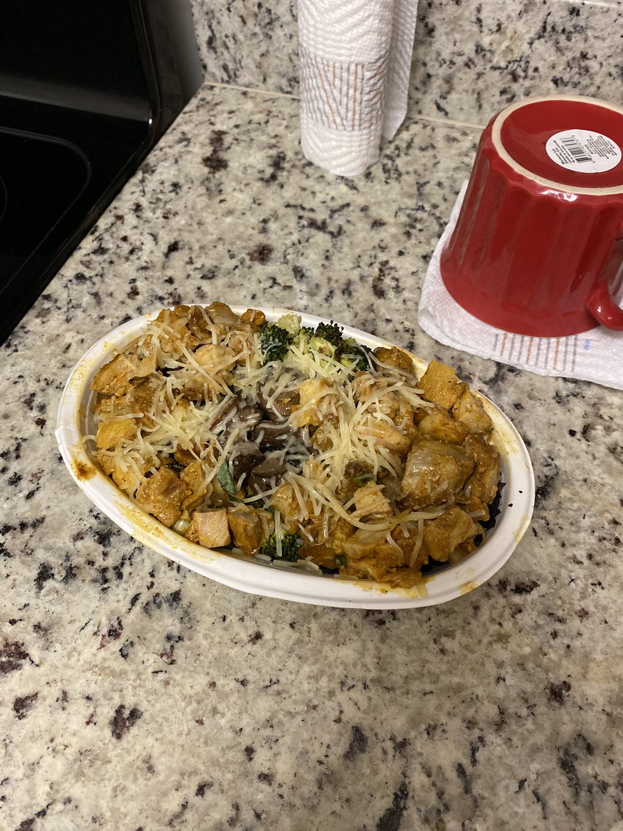 A bowl consisting of sweet potato noodles, black rice, broccoli ...