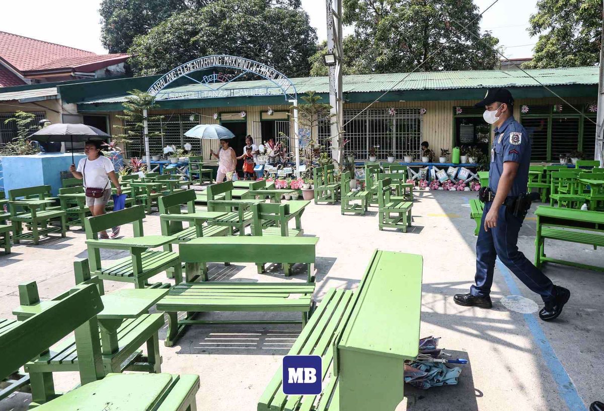 Policemen check the vicinity of Maximo V. Pangilinan Elementary School ...