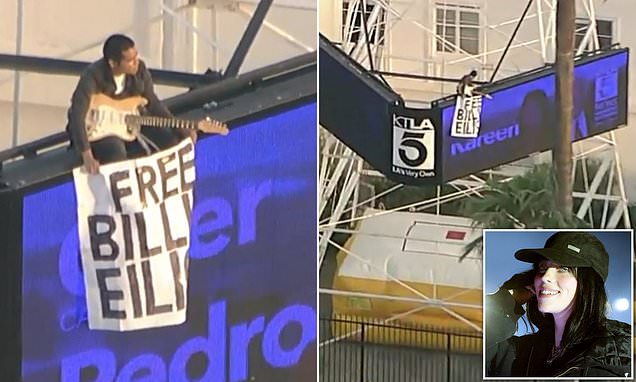 Daily Mail US on Twitter: "Man holding 'Free Billie Eilish' sign climbs TV tower along Hollywood ...