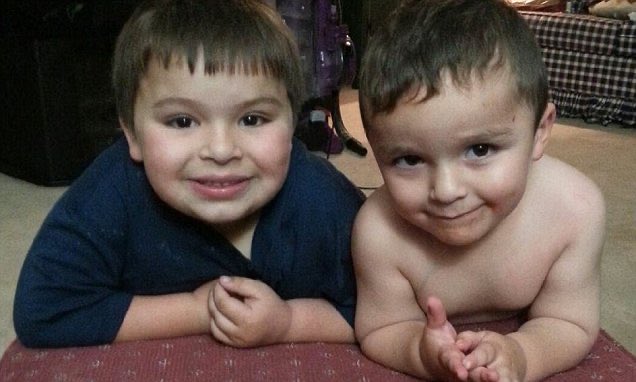 Molly, A woman in West Virginia, laid in bed with her two sons Delmer ...