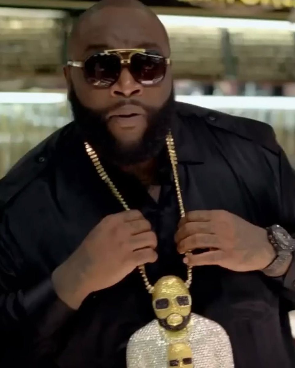 Rick Ross wearing a chain of himself wearing a chain of himself