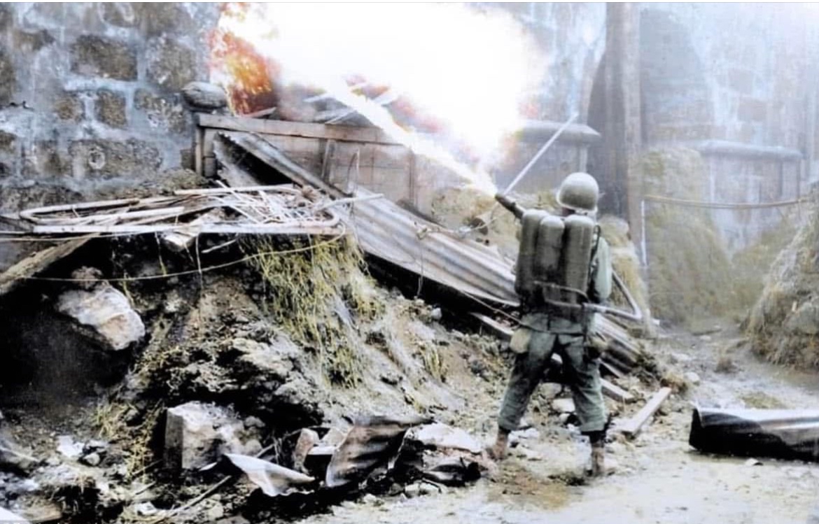 In February of 1945, an American soldier uses his flamethrower on ...