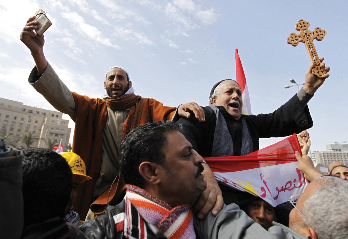 🇪🇬 A Muslim holding the Quran and a Coptic Christian holding a cross ...