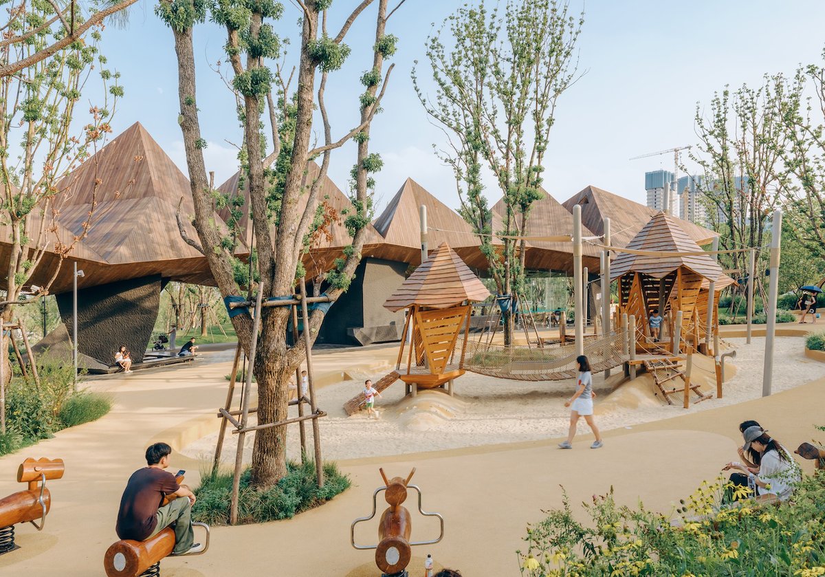 A faceted roof made from flat timber panels forms a mountain-like ...